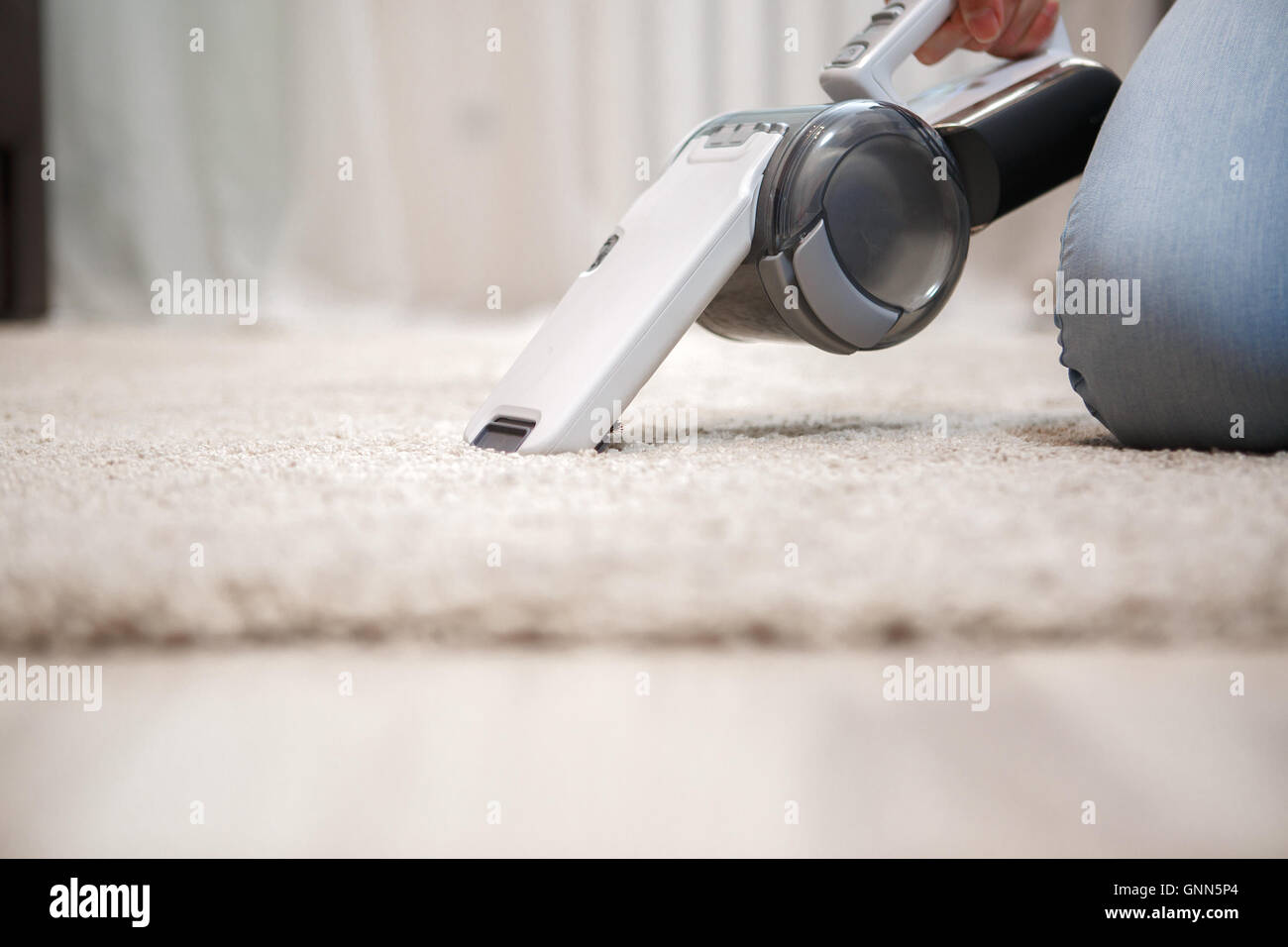 Process of cleaning carpet with help portable vacuum cleaner Stock ...