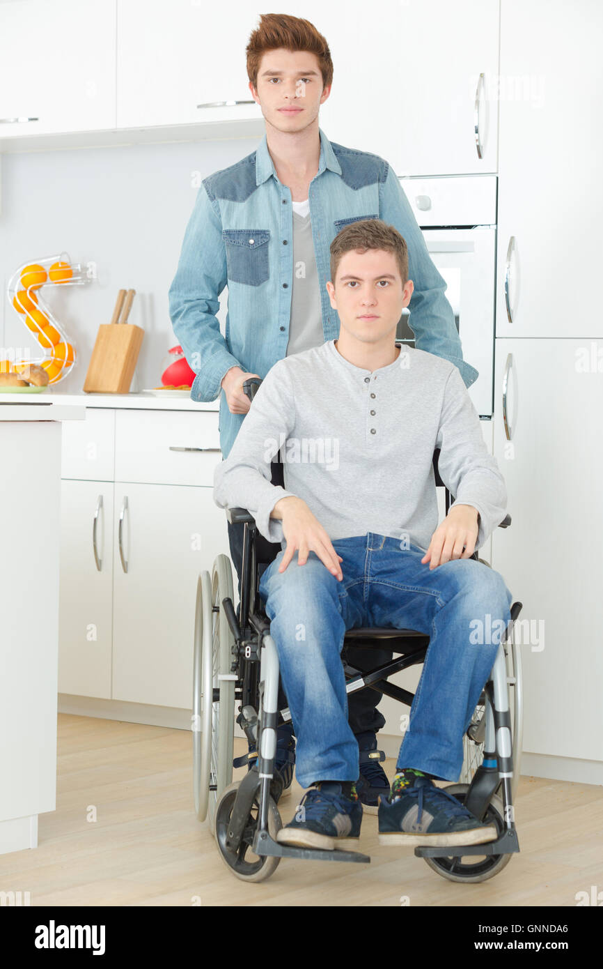 Helping a friend in a wheelchair Stock Photo - Alamy