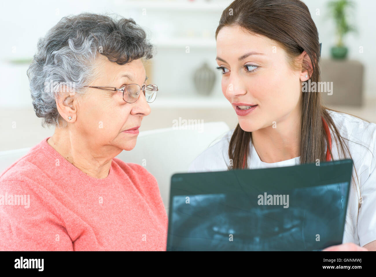 Showing x-ray to elderly patient Stock Photo - Alamy