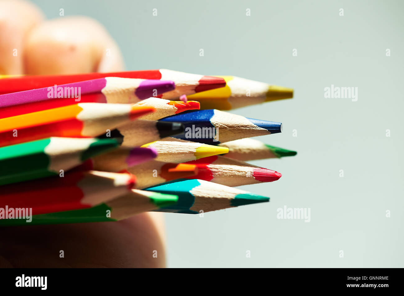 Colored pencils in children's hands, sharpened . Macro Stock Photo - Alamy