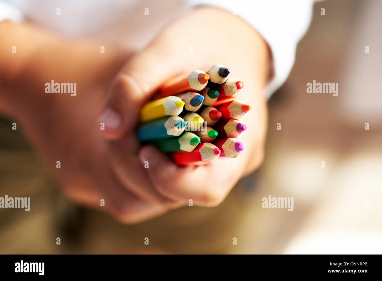 Colored pencils in children's hands, sharpened . Macro Stock Photo - Alamy