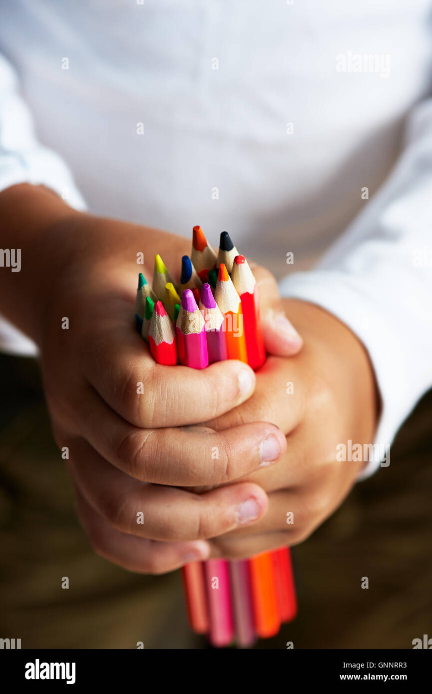 Colored pencils in children's hands, sharpened . Macro Stock Photo - Alamy