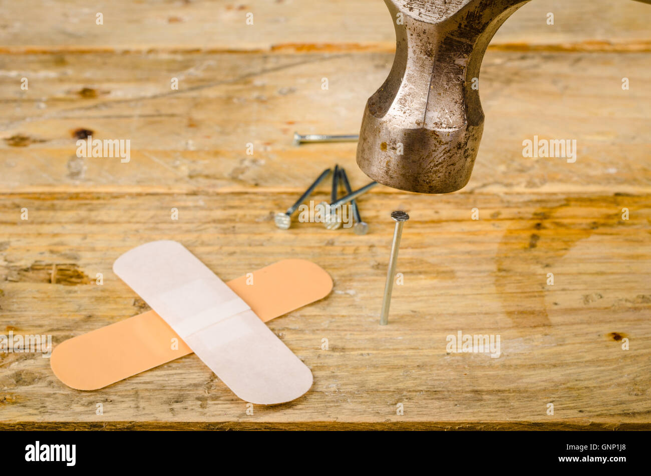 Hammer nails and band aid, a domestic DIY accident concept Stock Photo ...