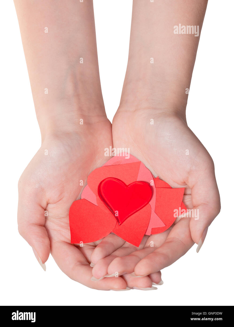 glass heart above pile of paper hearts on female palms isolated on ...