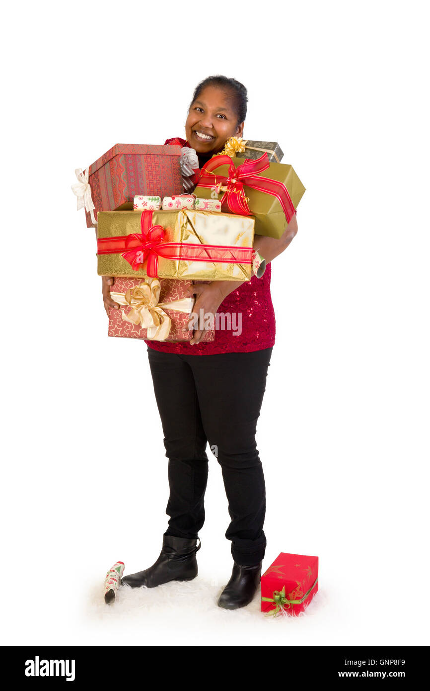 Smiling mature woman holding too many christmas presents Stock Photo ...