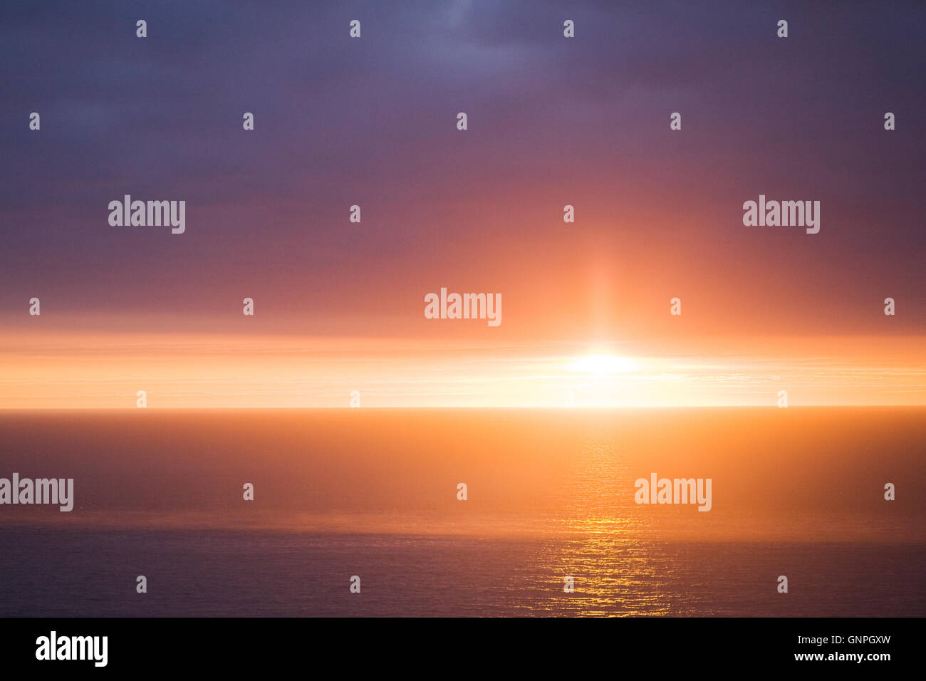 Sun setting over the Ocean Stock Photo - Alamy