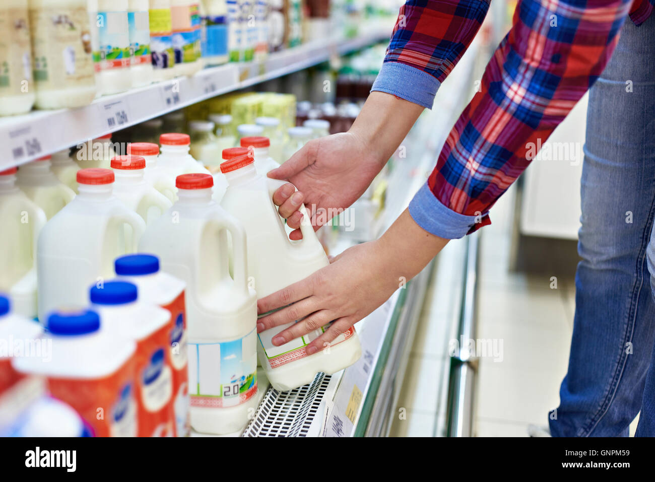 Woman shopping milk in grocery store Stock Photo - Alamy