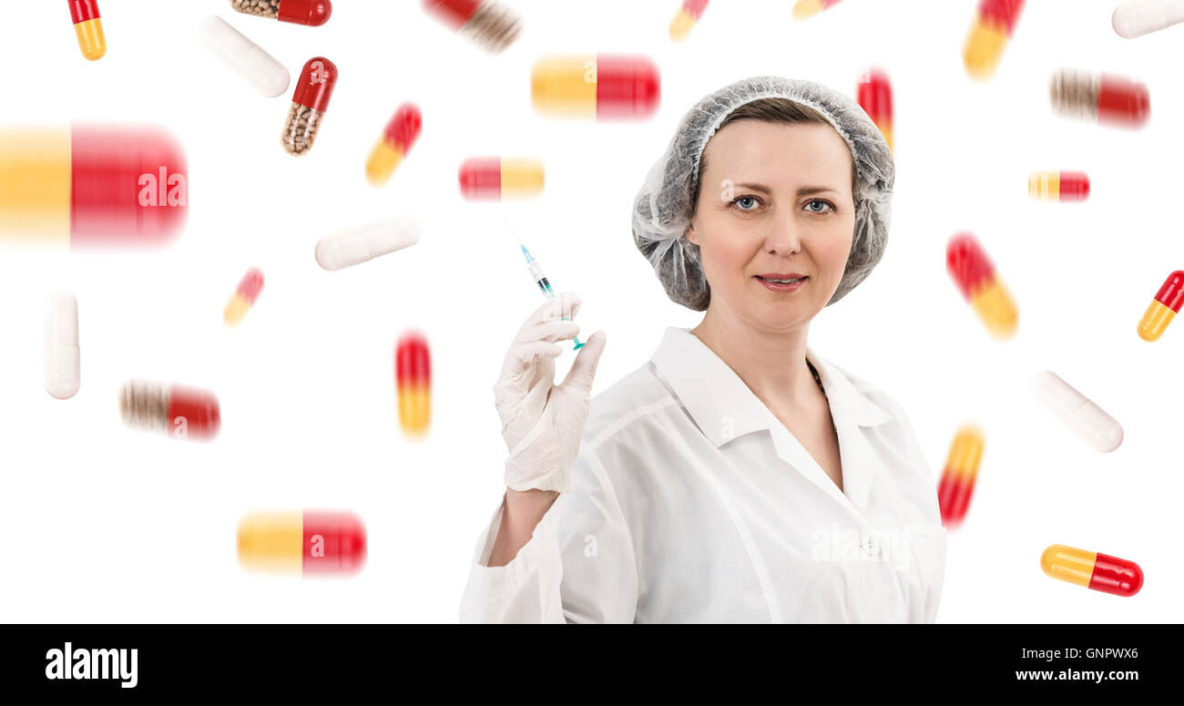 Smiling female doctor in uniform standing over falling drugs background ...