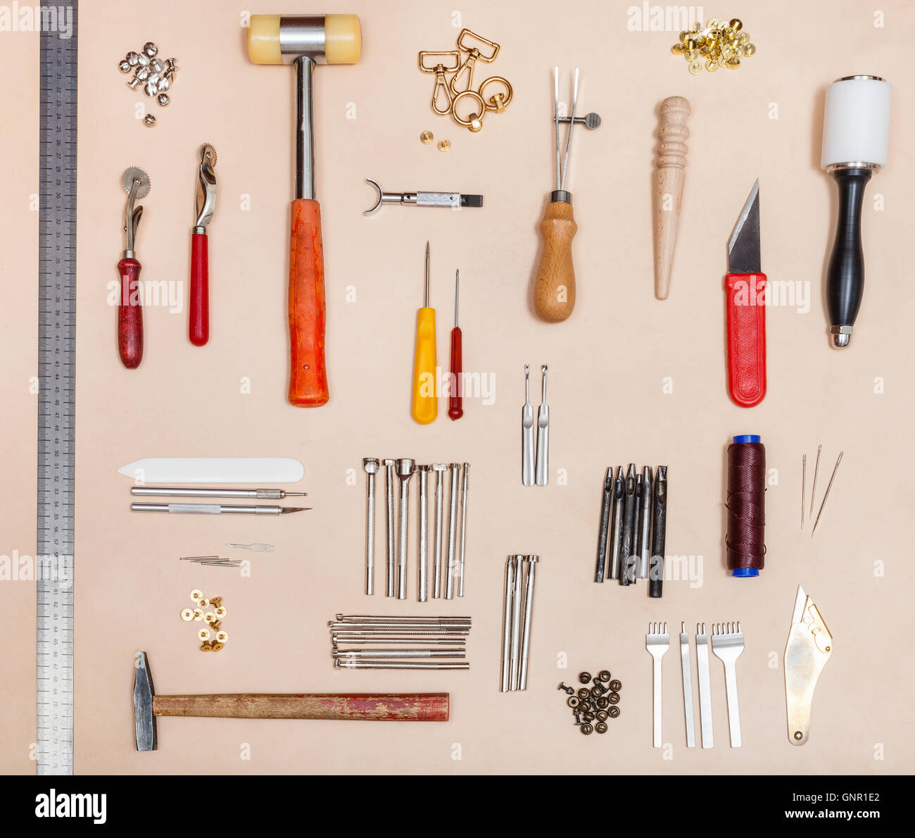 top view of collection various leathercrafting instruments on natural ...