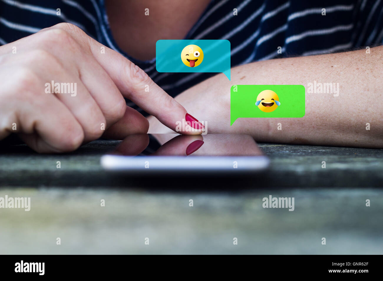 Close-up of a hands of a woman using emojis to chat. All screen ...