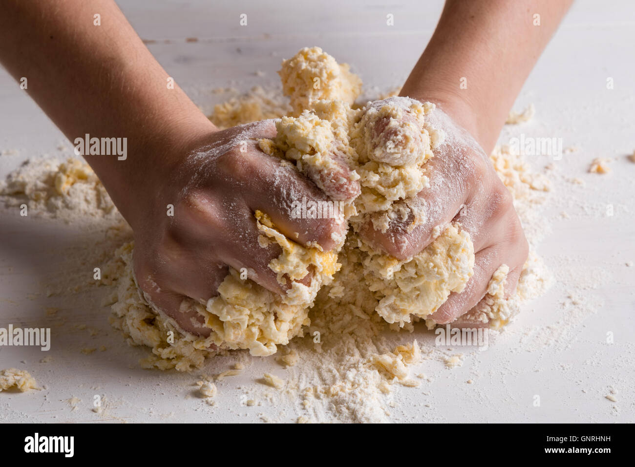 making raw dough by female hands on white table Stock Photo - Alamy
