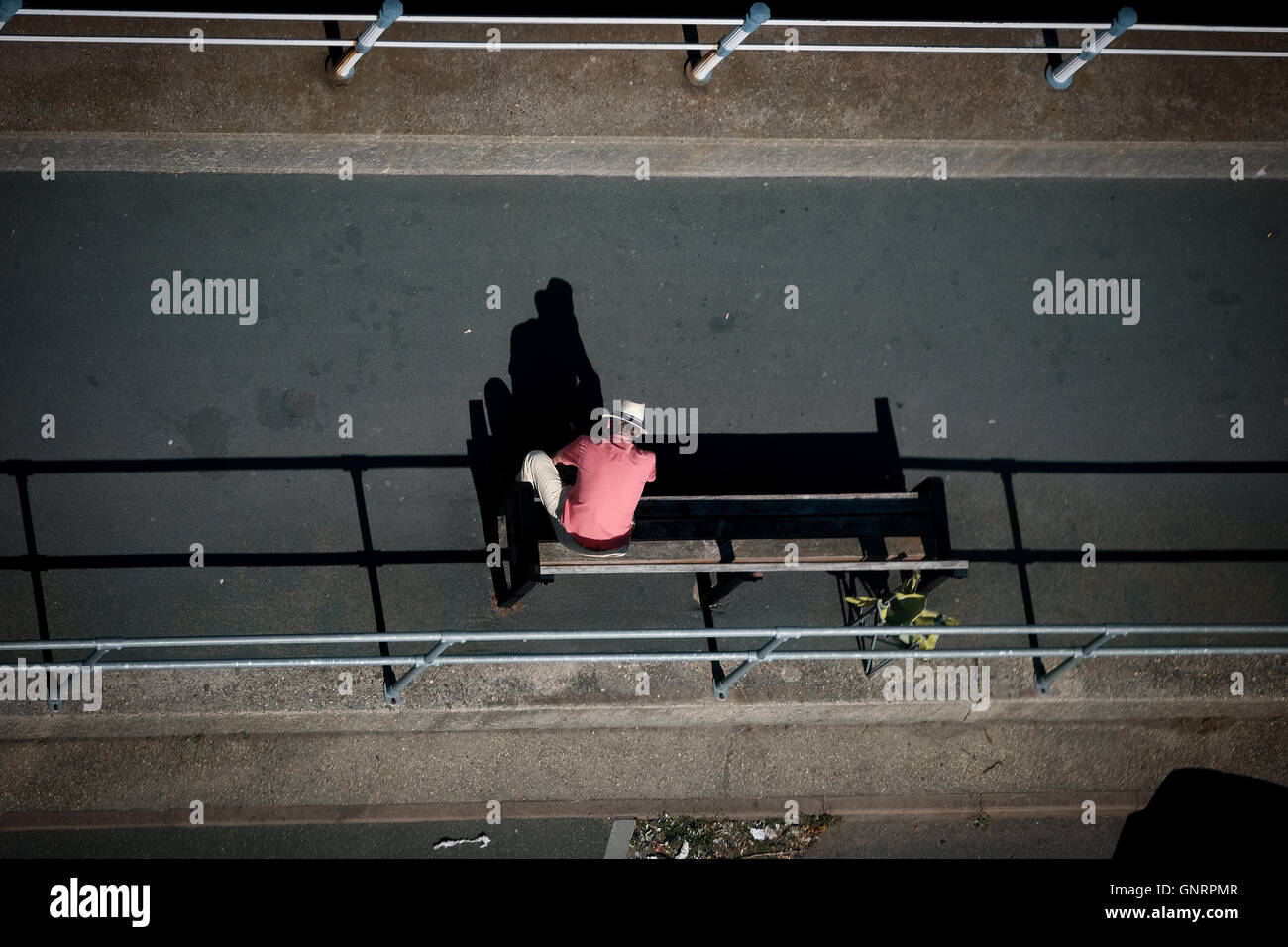 aerial view of a man sitting on a bench Stock Photo - Alamy
