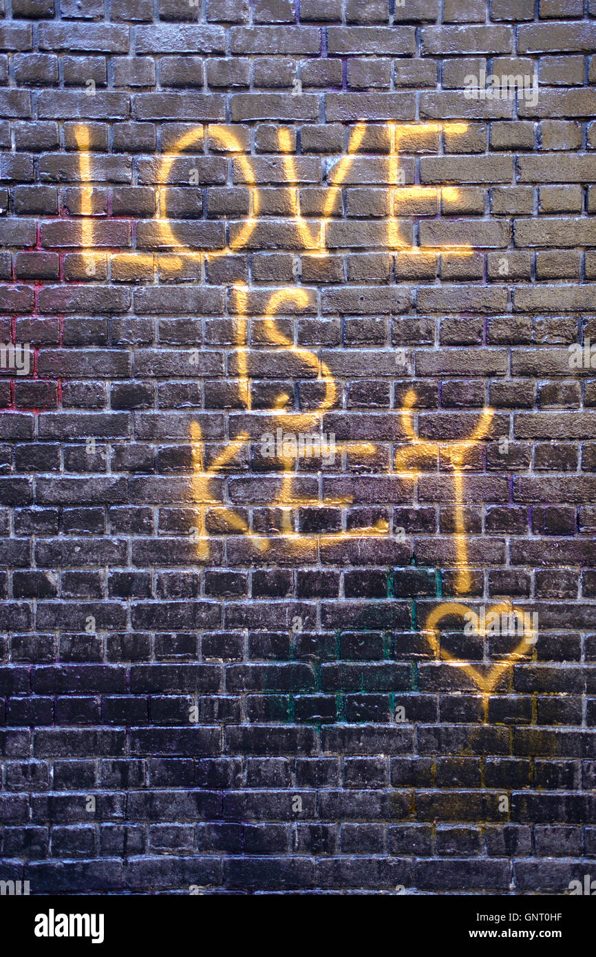 "Love Is Key" concept written on the brick wall Stock Photo - Alamy