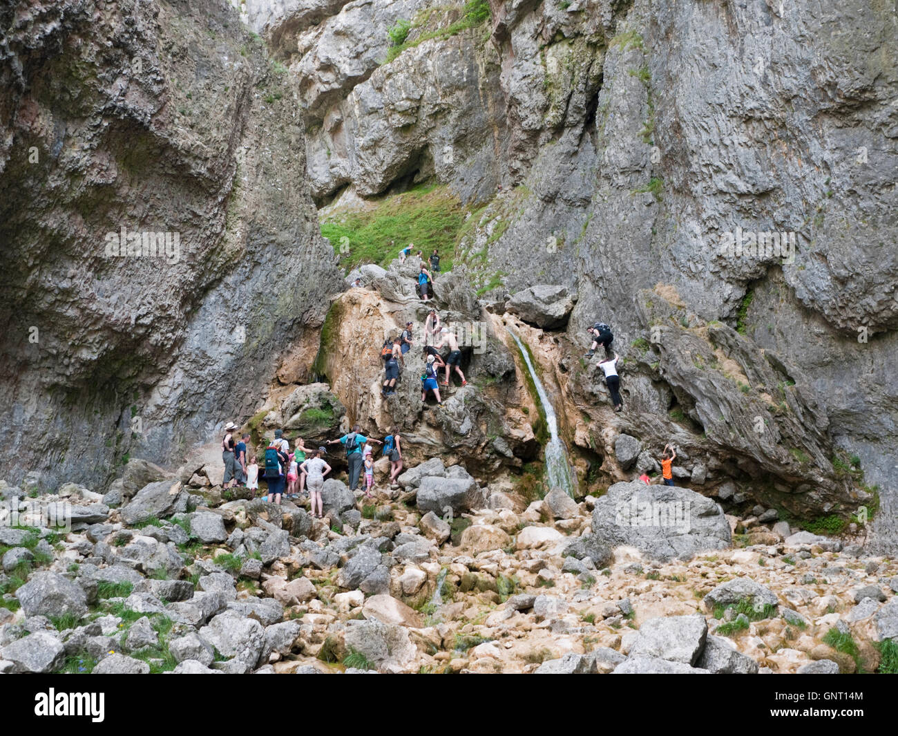 Walkers climbing the waterfall at Gordale Scar, a deep gorge near ...