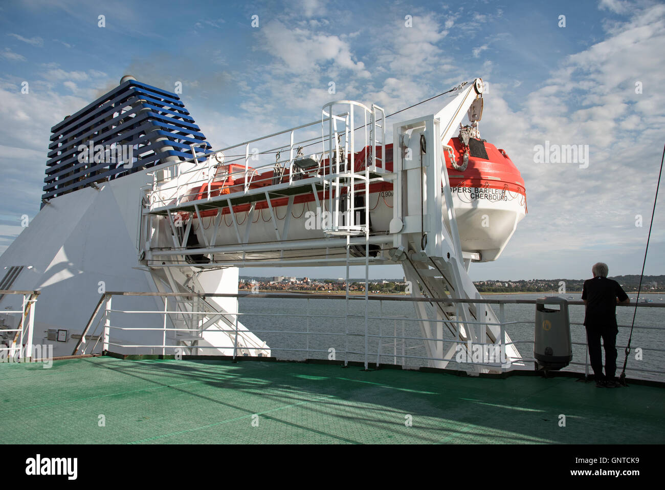 A ship's deck with engine exhaust pipe tower and a lifeboat Stock Photo ...