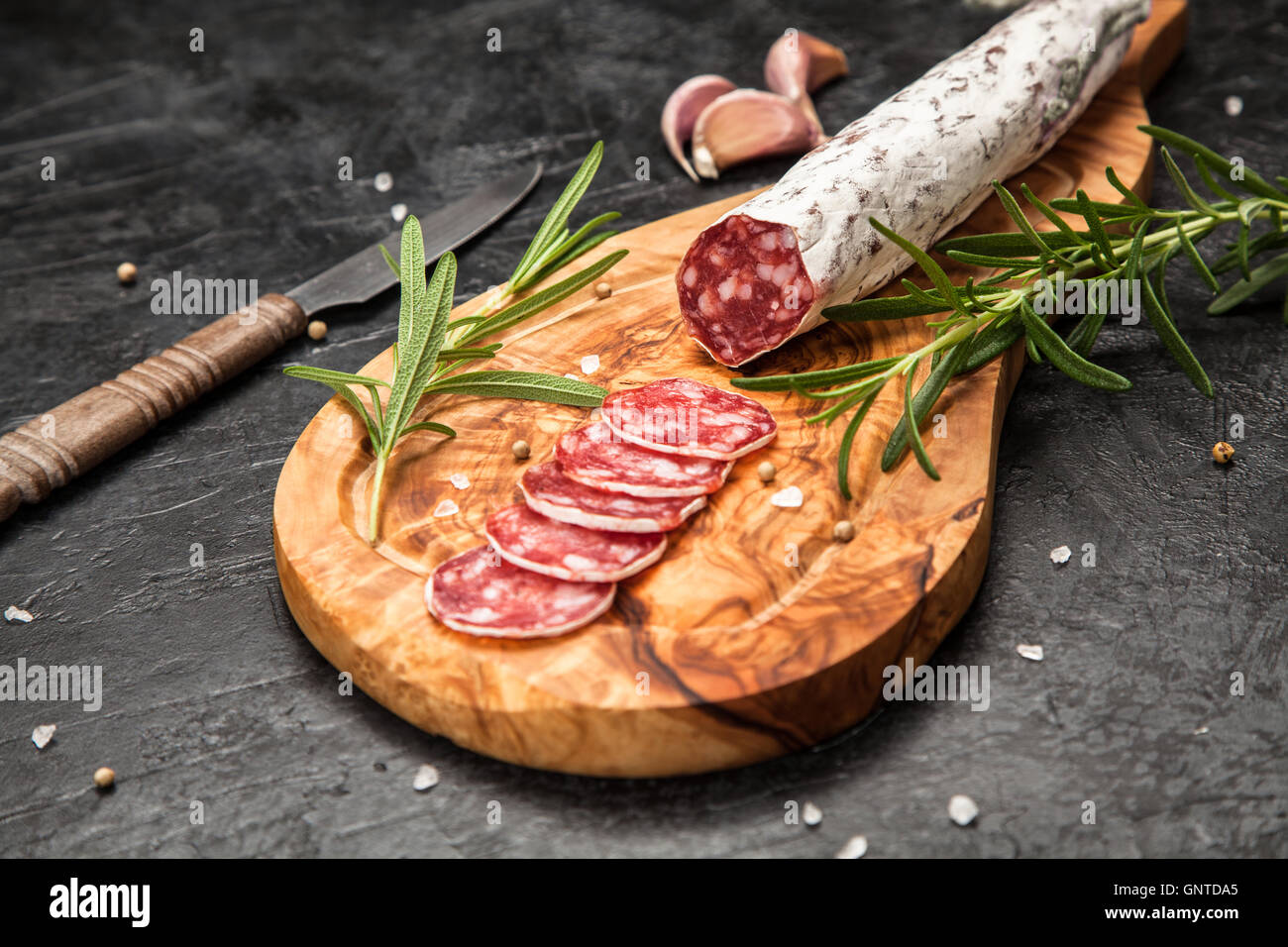 Salami on dark background Stock Photo - Alamy