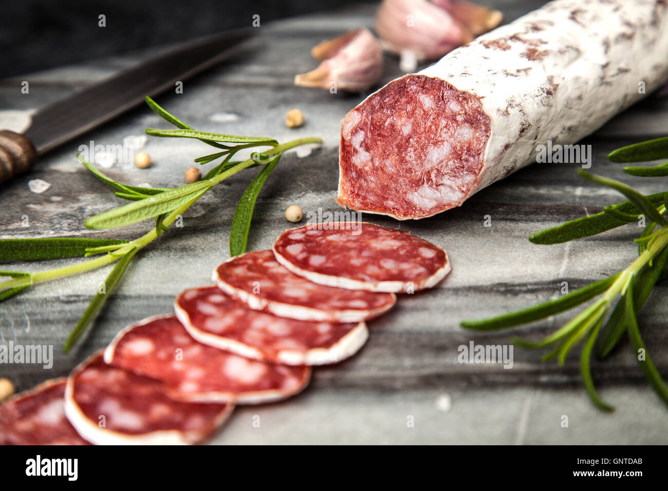Salami on dark background Stock Photo - Alamy