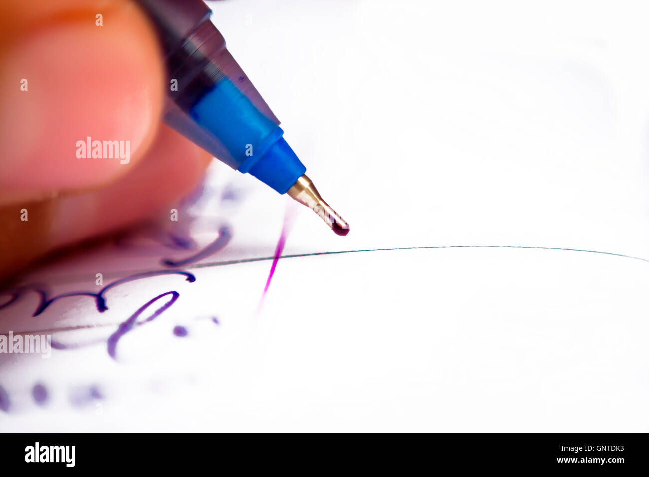 Human hand holding pen on white paper,isolated, selective focus ...