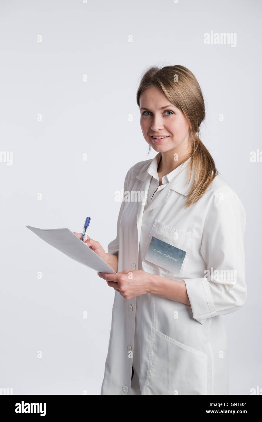 Cheerful medical doctor woman taking notes. Isolated on white Stock ...