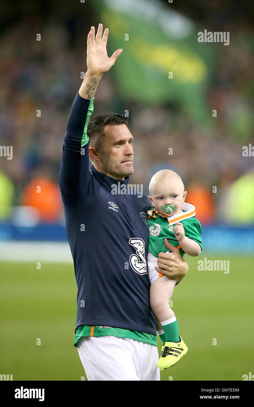 Republic of Ireland's Robbie Keane waves to the fans with his son ...