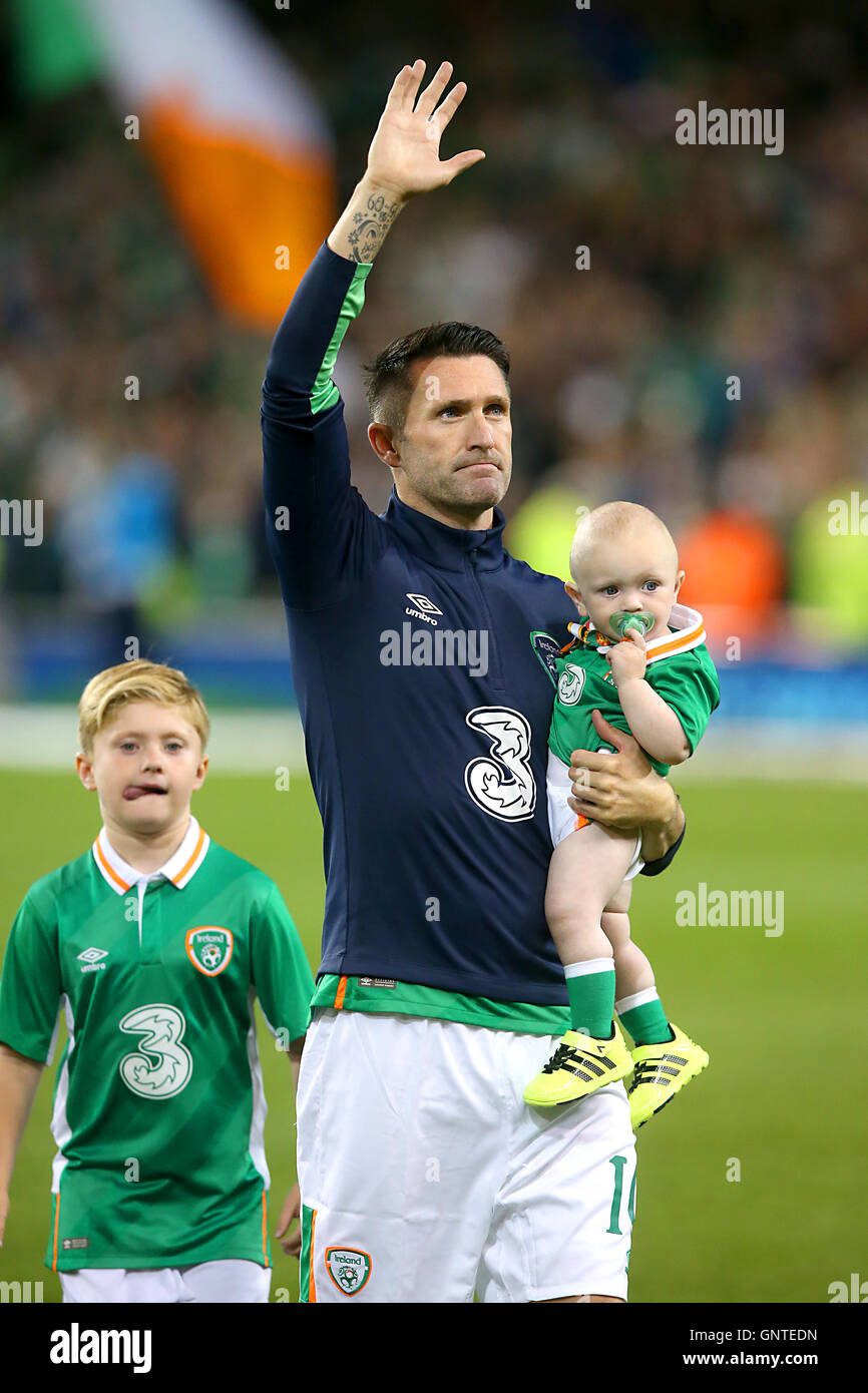 Republic of Ireland's Robbie Keane waves to the fans with his children ...
