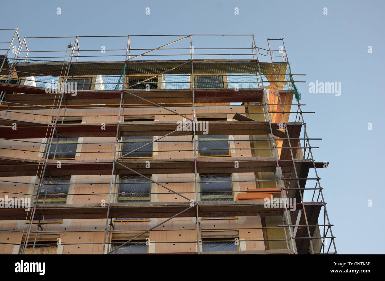 Extensive scaffolding providing platforms for work on a new apartment ...