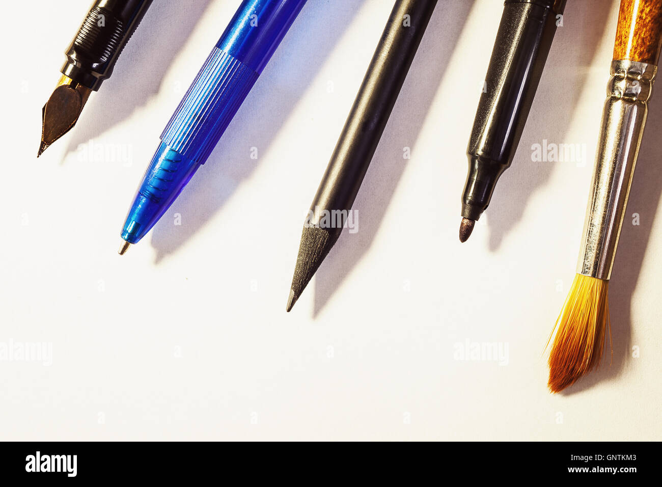 Various tools for writing or painting, conceptual composition on white ...