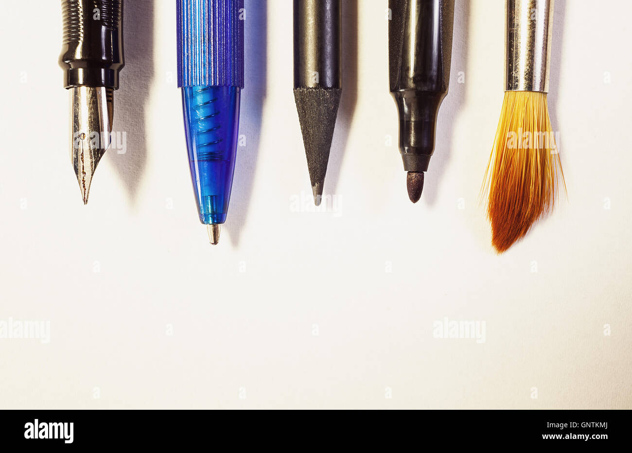 Various tools for writing or painting, conceptual composition on white ...