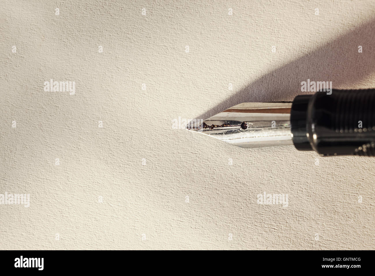 Closeup view of an old pen on white paper Stock Photo - Alamy