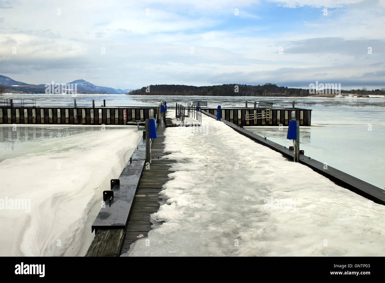 A dock and lake iced over in the winter Stock Photo - Alamy
