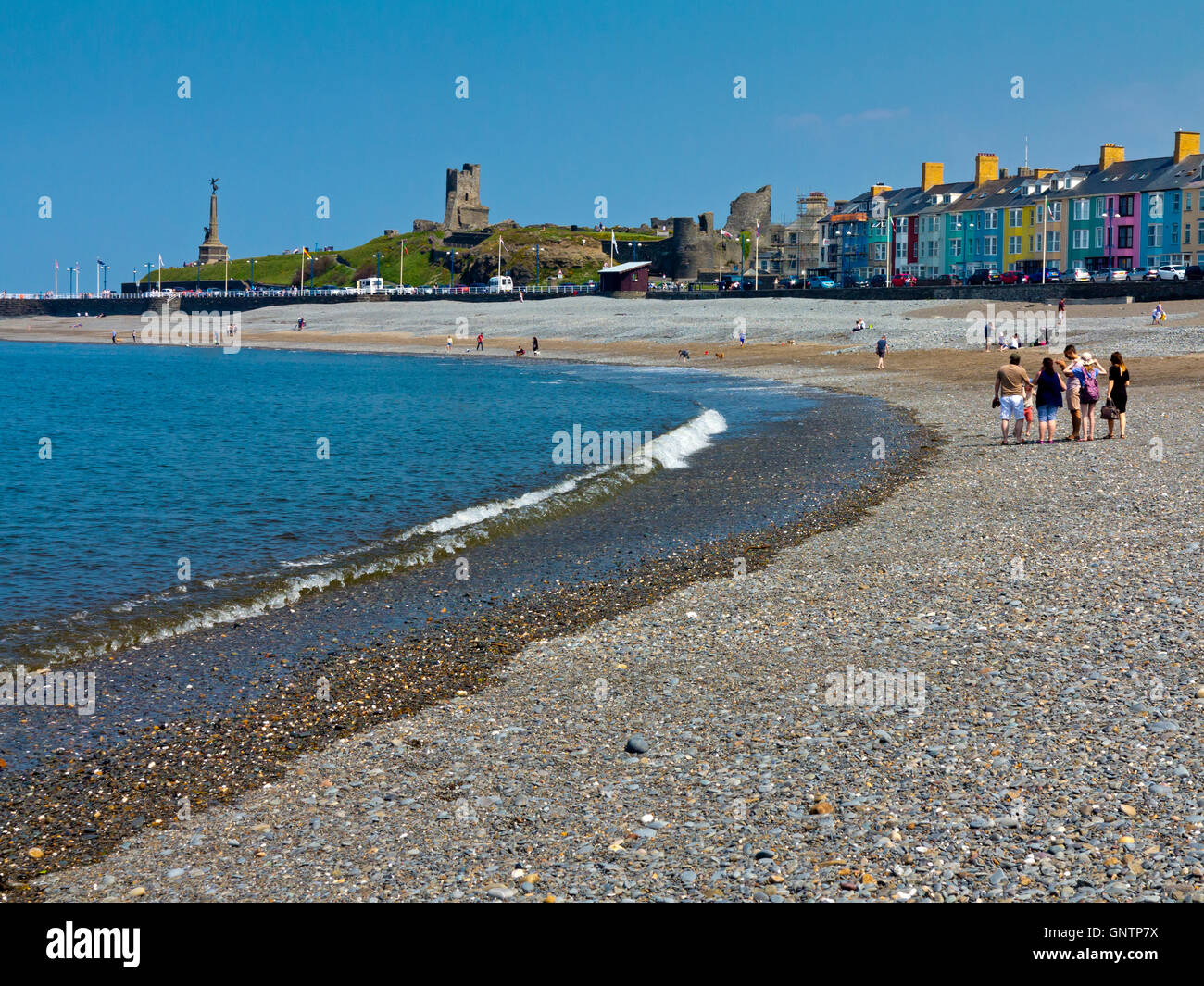 The beach and promenade with brightly painted houses at Aberystwyth a ...
