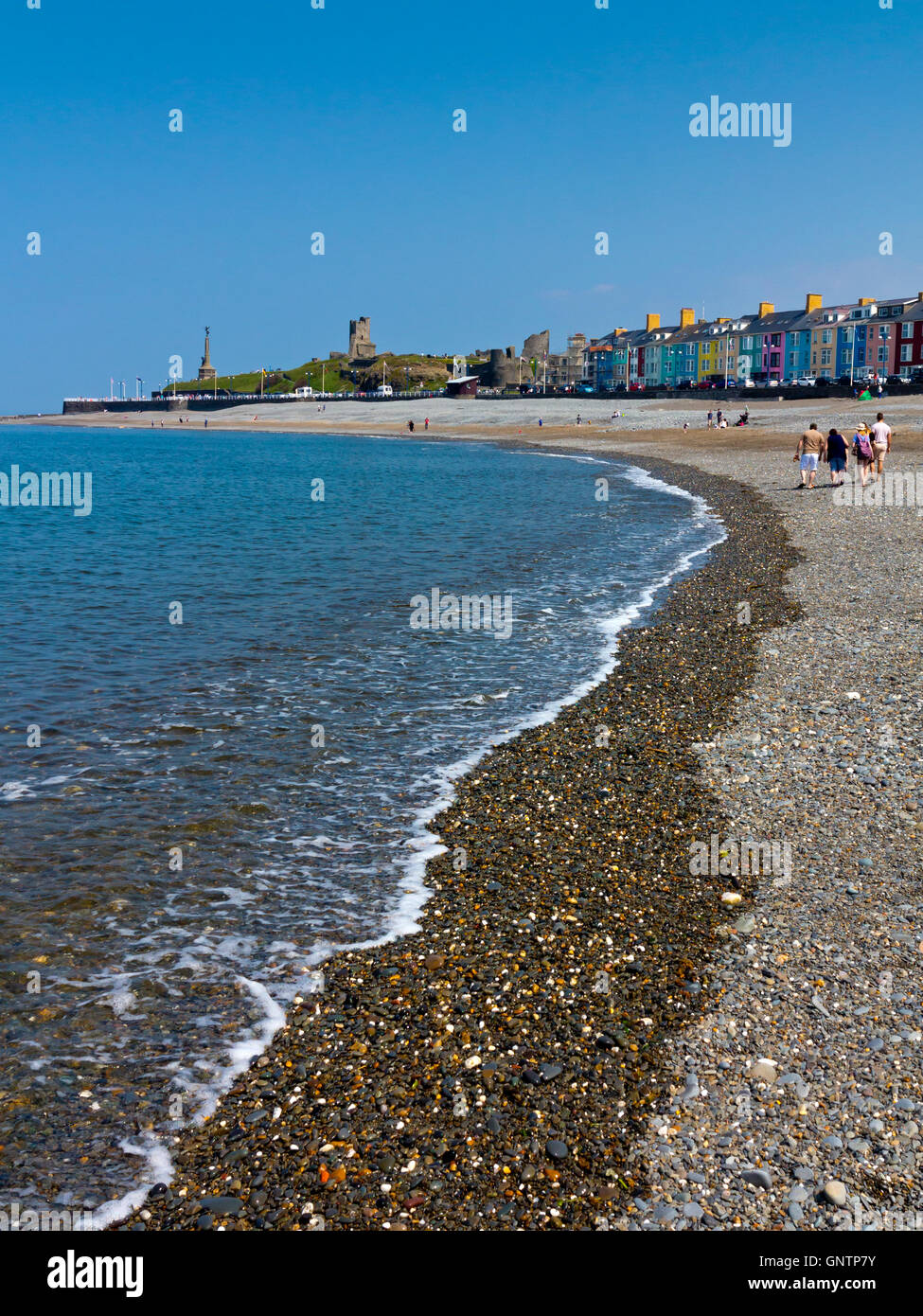 The beach and promenade with brightly painted houses at Aberystwyth a ...
