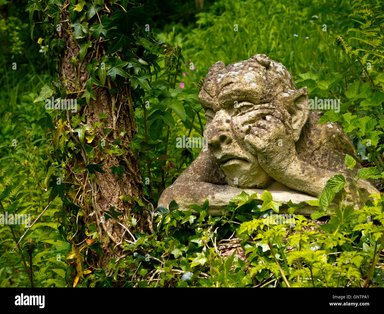 Stone statue of sad man in the Cascades Garden at Bonsall near Matlock ...
