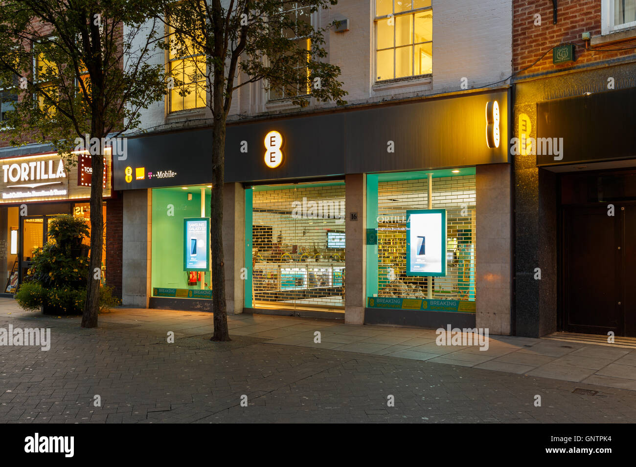 Frontage of the EE mobile store at night on Clumber Street. In ...
