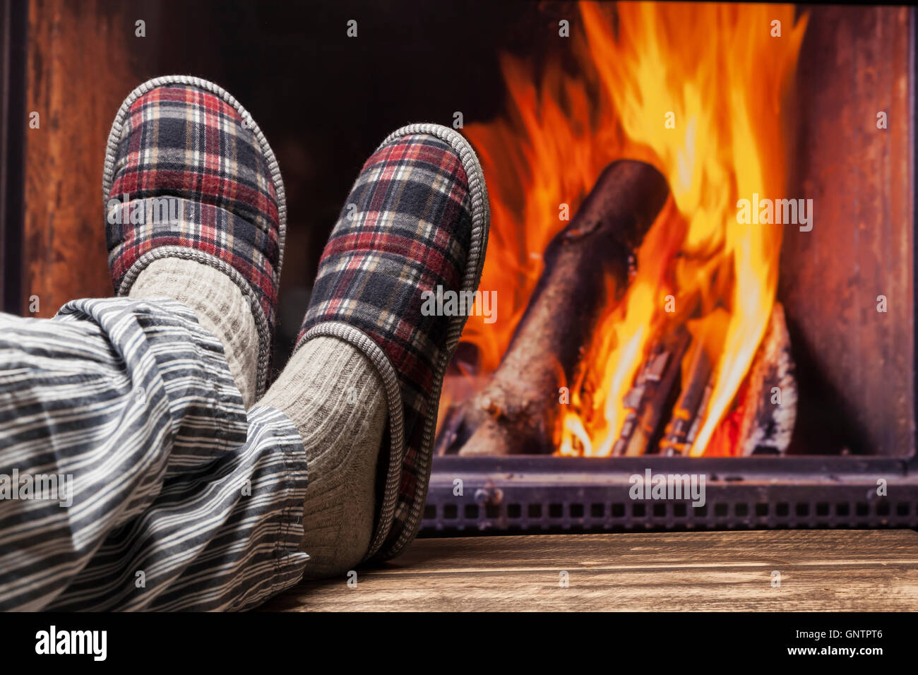 Man relaxing by fireplace hi-res stock photography and images - Alamy