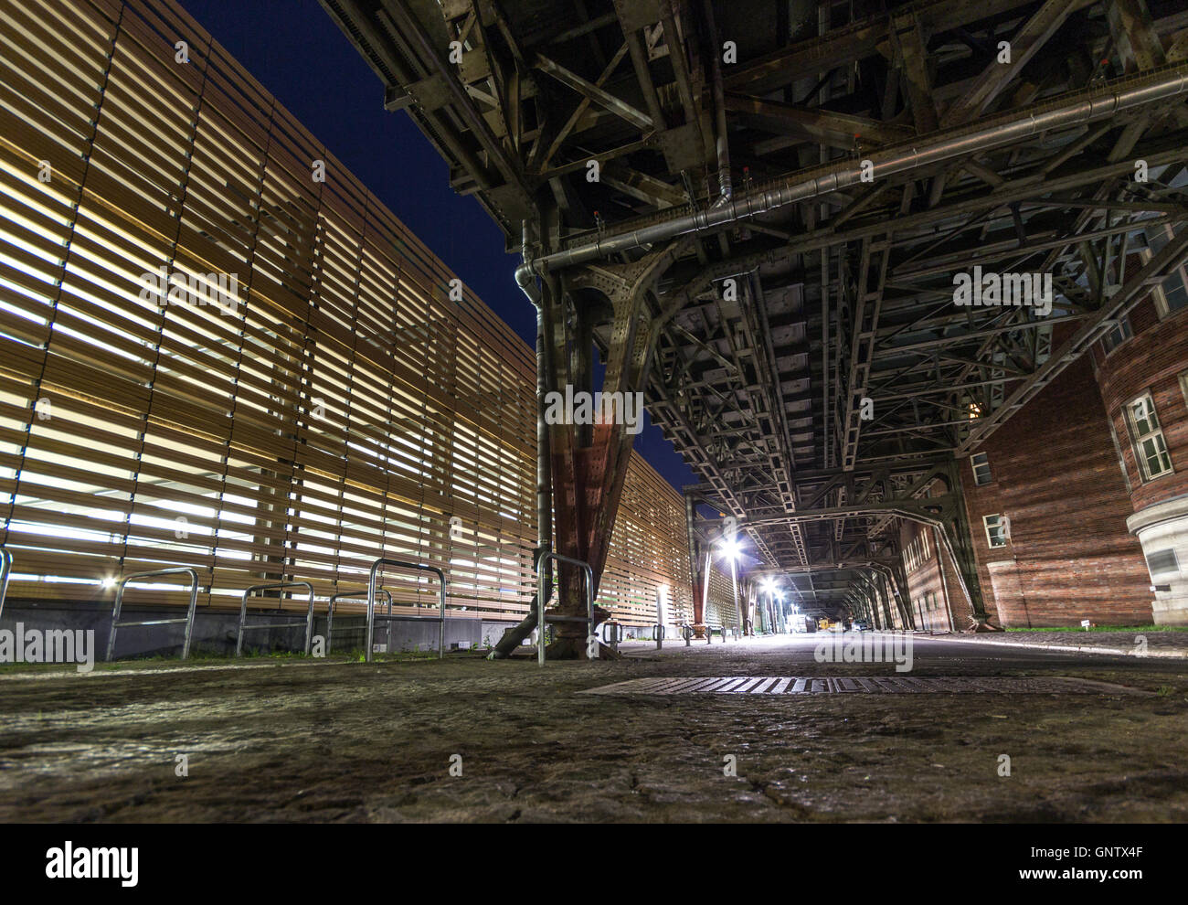 Under steel bridge, empty street at night Stock Photo - Alamy