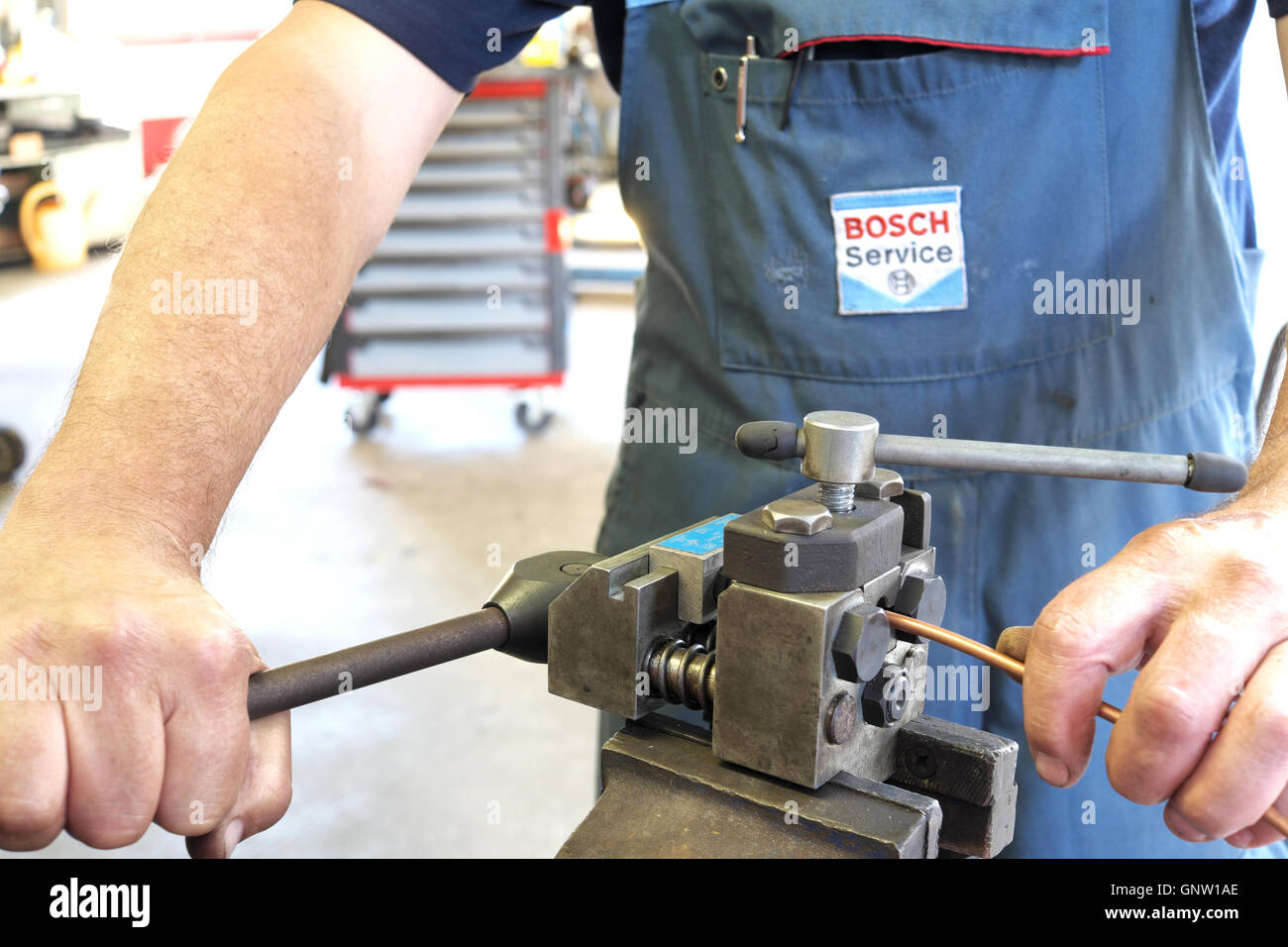 auto mechanic manufactures a copper brake pipe Stock Photo - Alamy