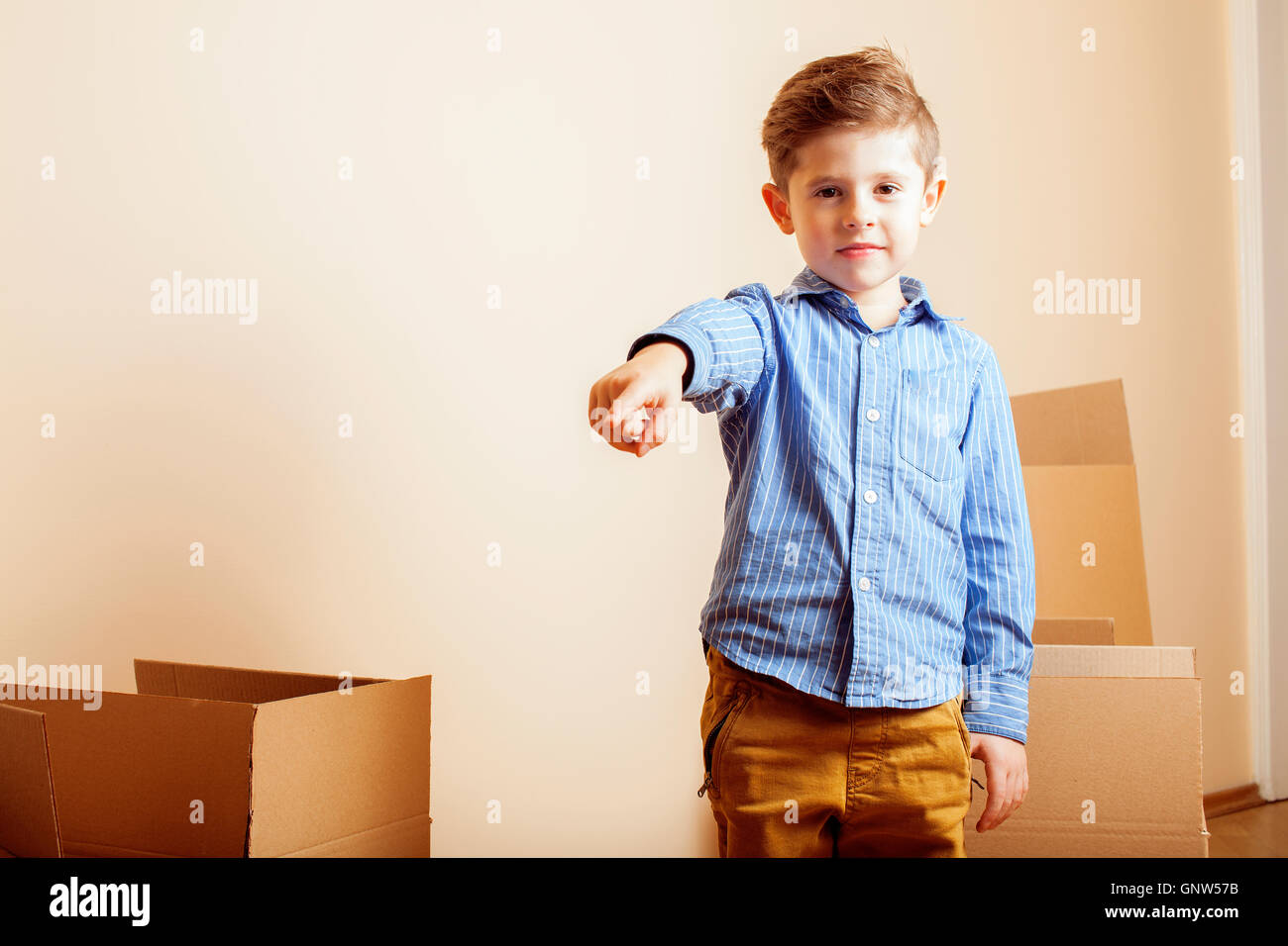 little cute boy in empty room, remoove to new house. home alone emong ...