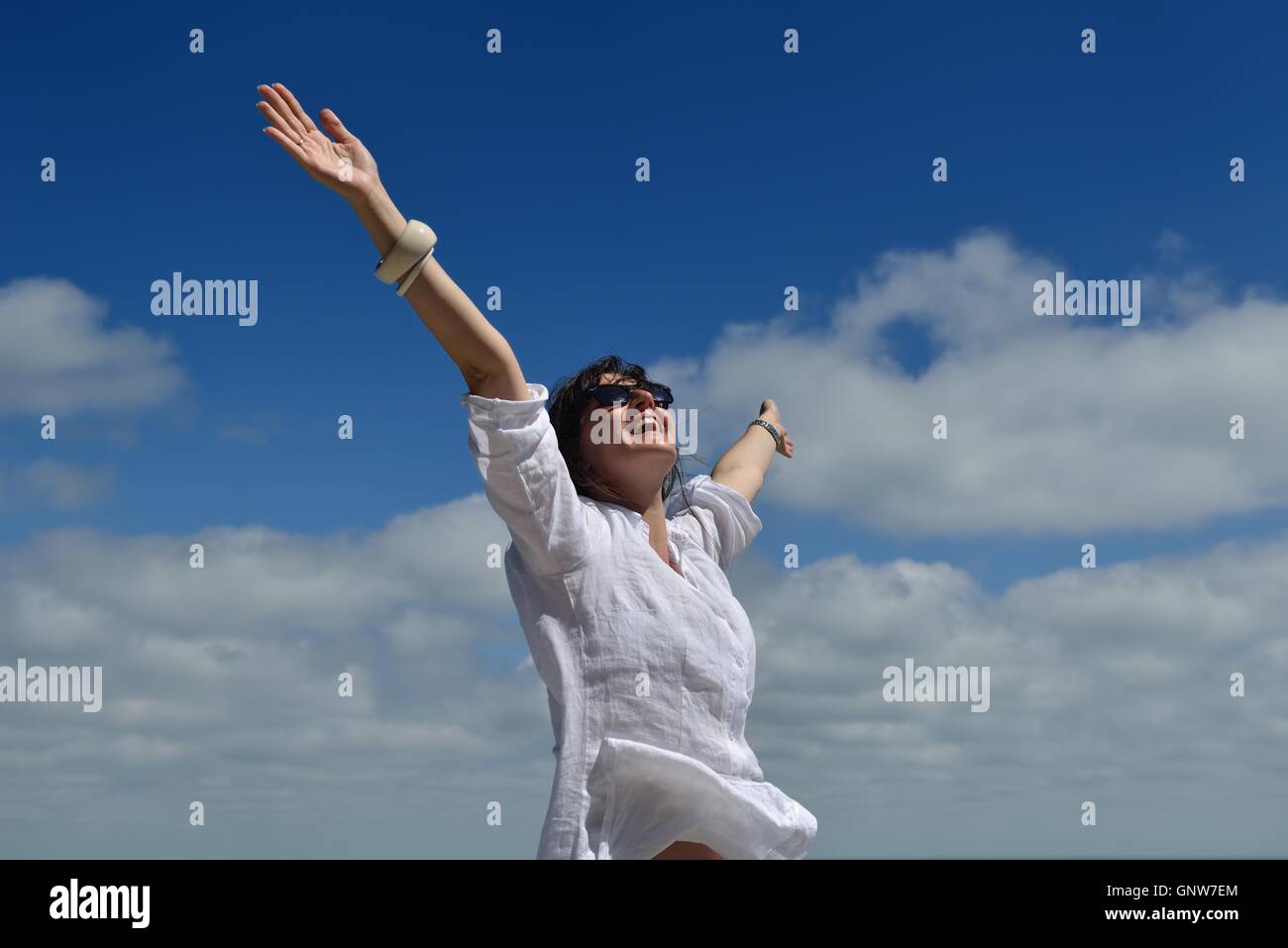 young woman with spreading arms to sky Stock Photo - Alamy