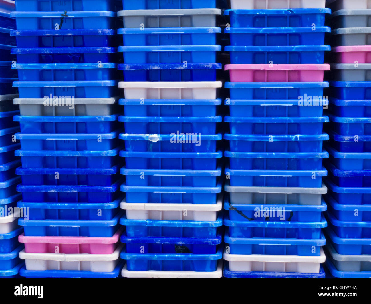 Stack of empty colorful plastic fishery containers Stock Photo - Alamy
