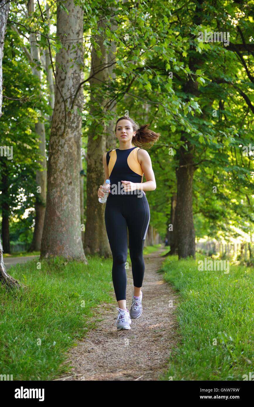 Young beautiful woman jogging Stock Photo - Alamy