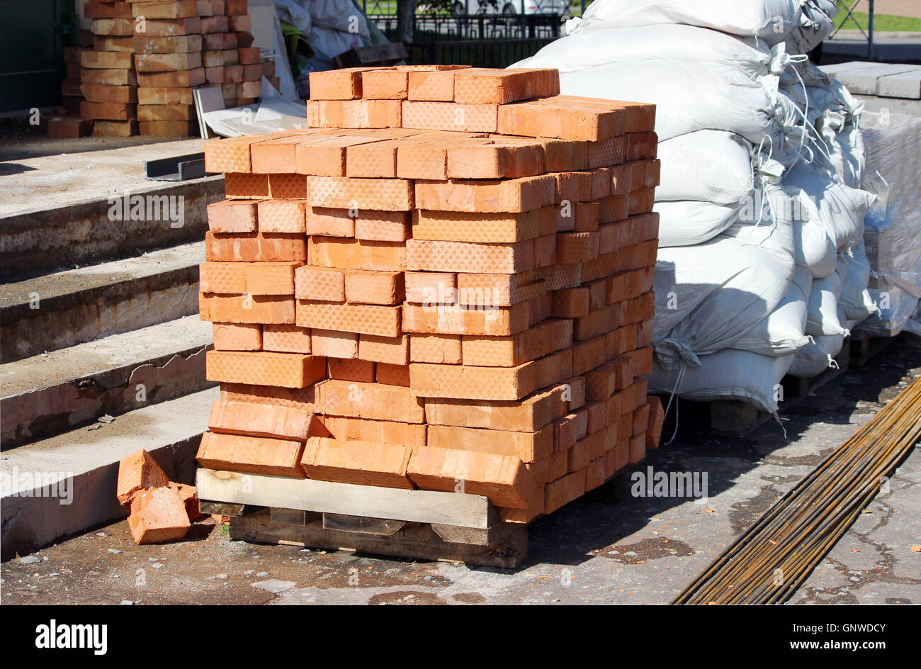 New bricks are stacked on a pallet and bags near the trade pavilion ...