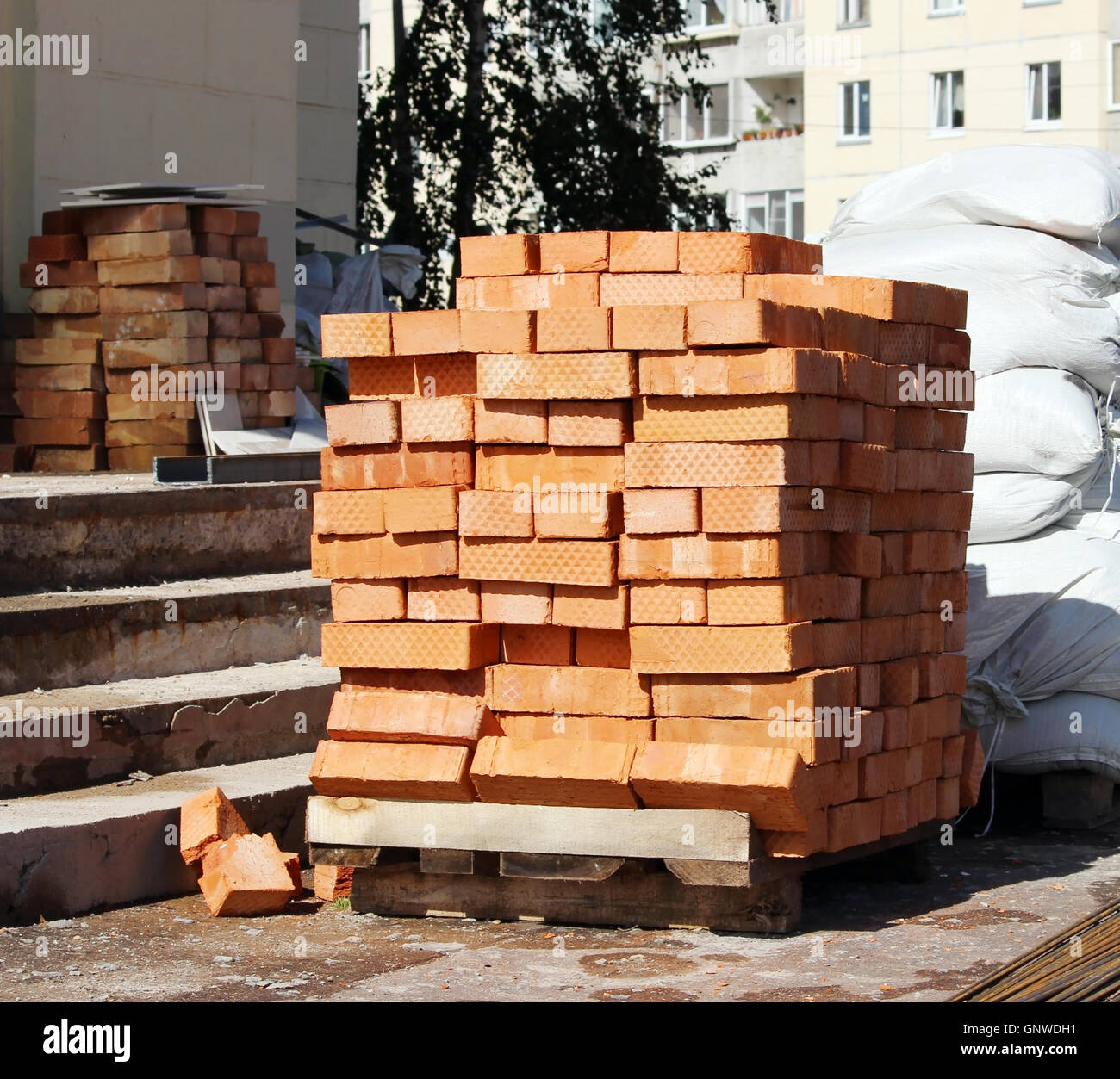 New bricks are stacked on a pallet and bags near the trade pavilion ...