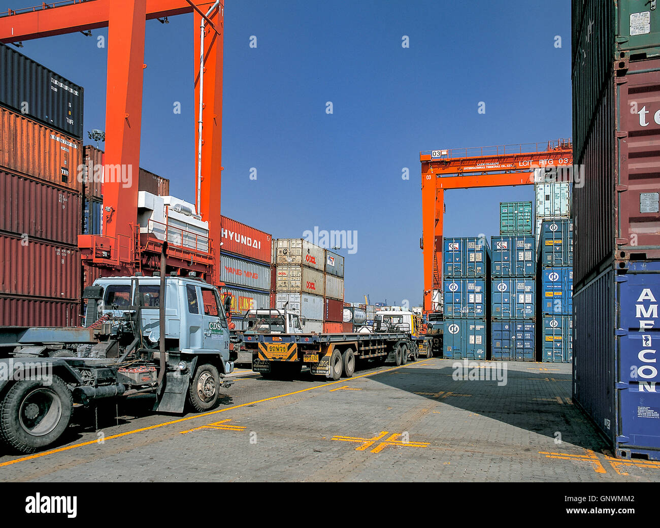 Truck Moving Containers in Port Shipyard Stock Photo - Alamy