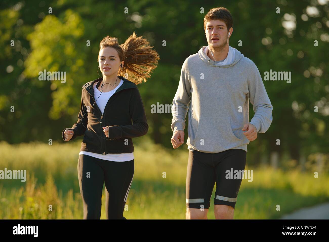 Young couple jogging Stock Photo - Alamy
