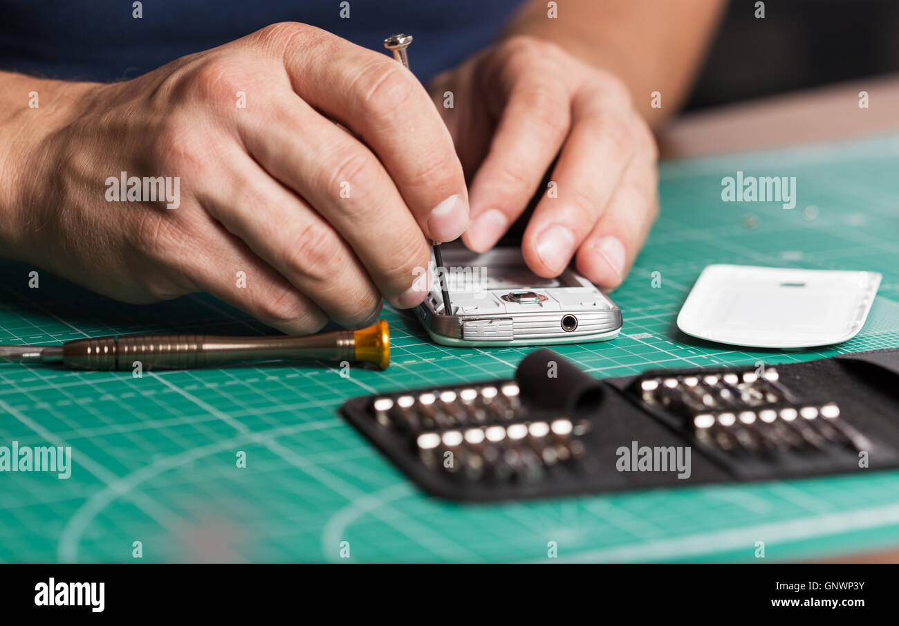 Man repairing broken smartphone, close up photo Stock Photo - Alamy