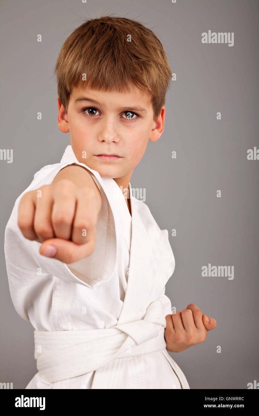 Karate boy in white kimono fighting Stock Photo - Alamy