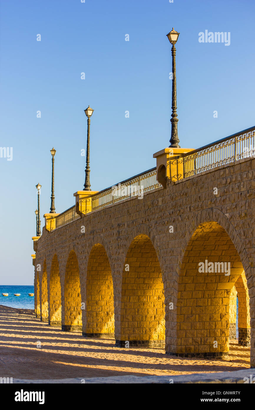 The arched stone colonnade with lanterns Stock Photo - Alamy