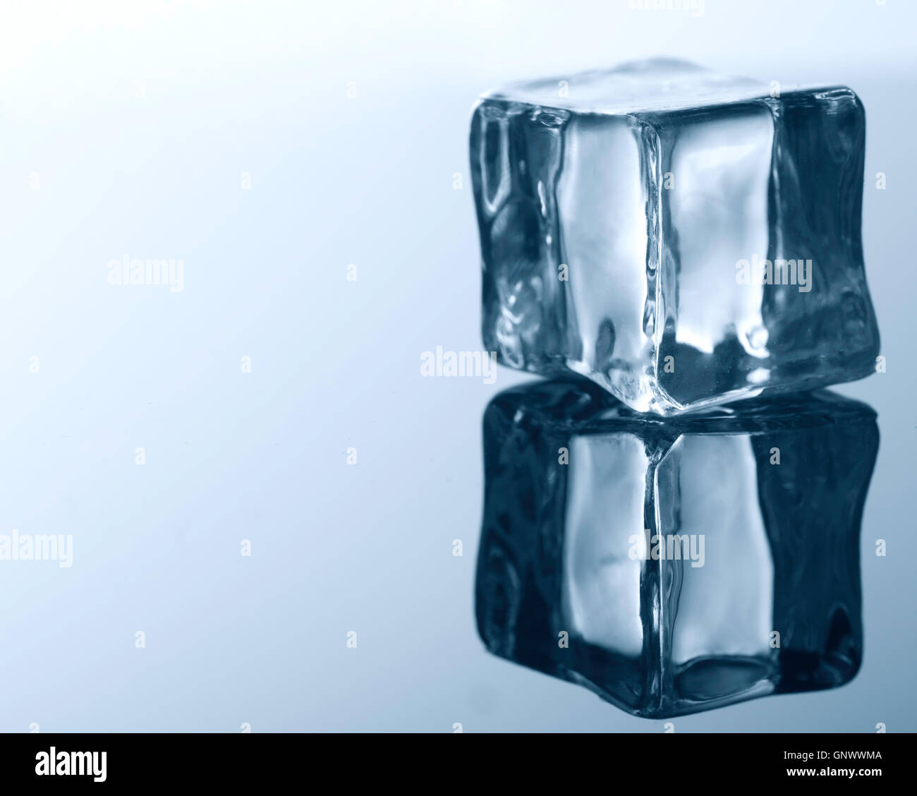 ice cube on blue background Stock Photo - Alamy