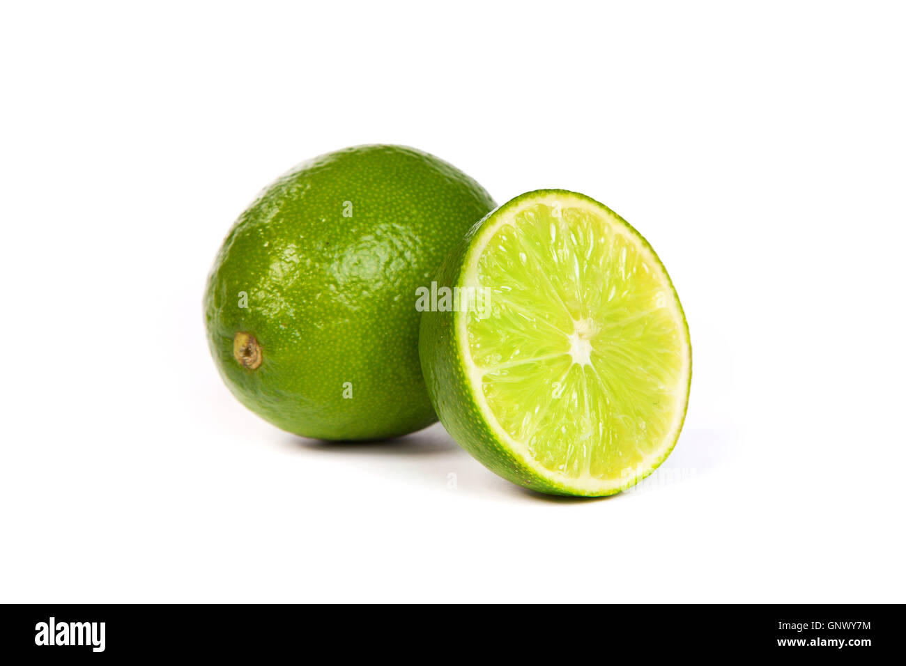 One whole lime and one half lime on white Stock Photo - Alamy